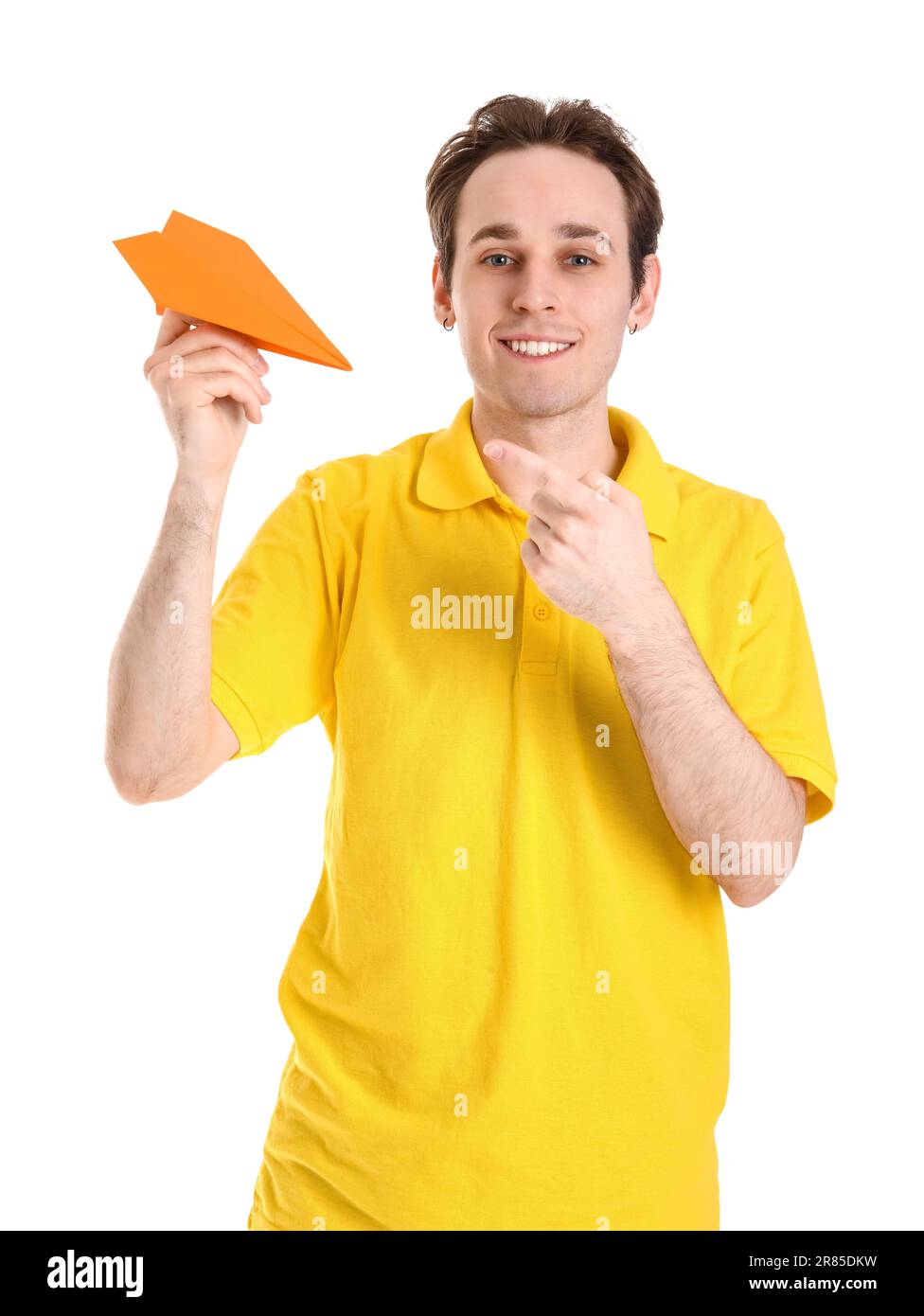 Young man pointing at paper plane on white background Stock Photo - Alamy