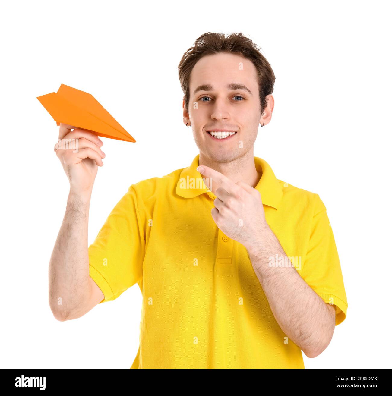 Young man pointing at paper plane on white background Stock Photo - Alamy