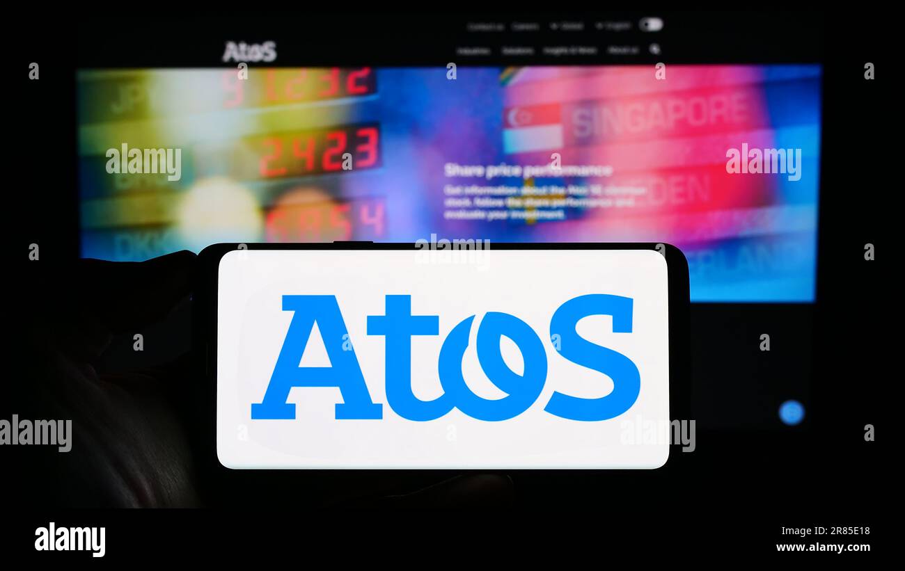 Person holding mobile phone with logo of French information technology ...