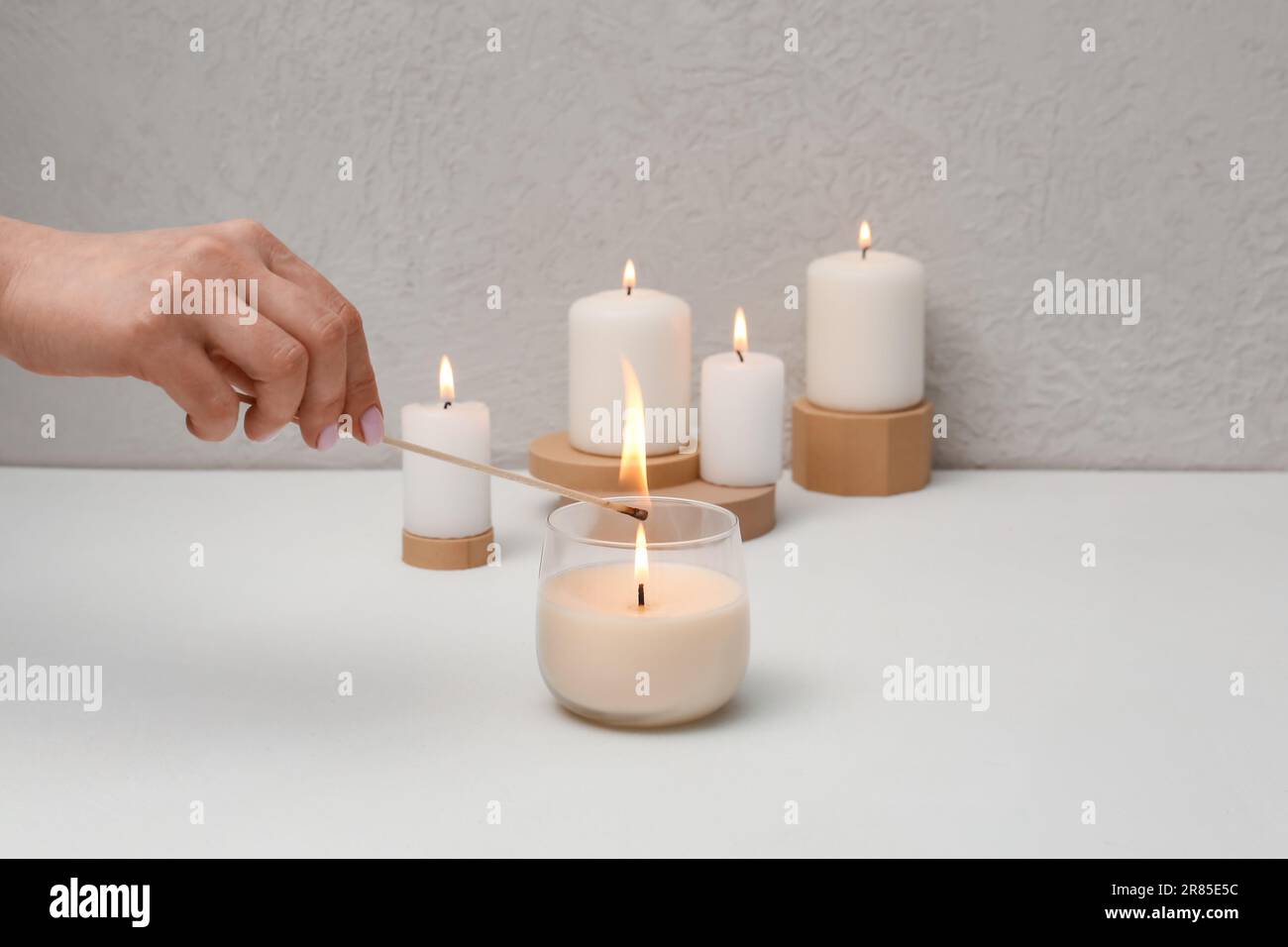 Beautiful woman lighting candle table hi-res stock photography and ...