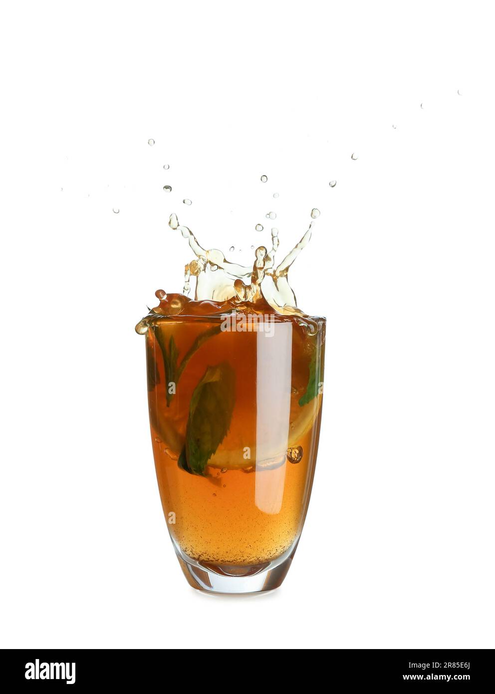 Glass of ice tea with splashes on white background Stock Photo - Alamy