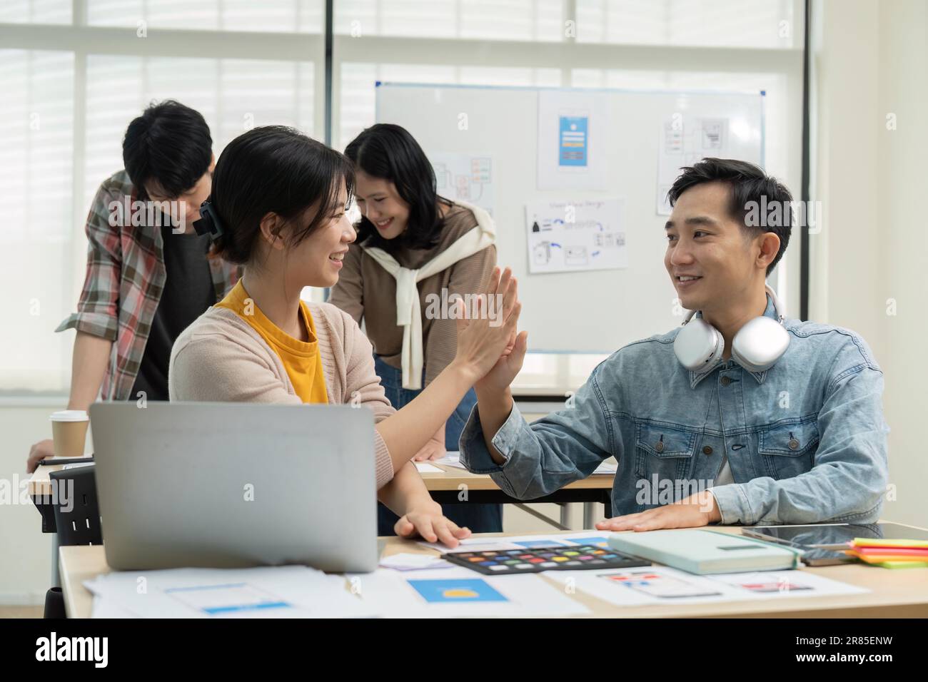 Group of Asia young creative people celebrating giving five after ...