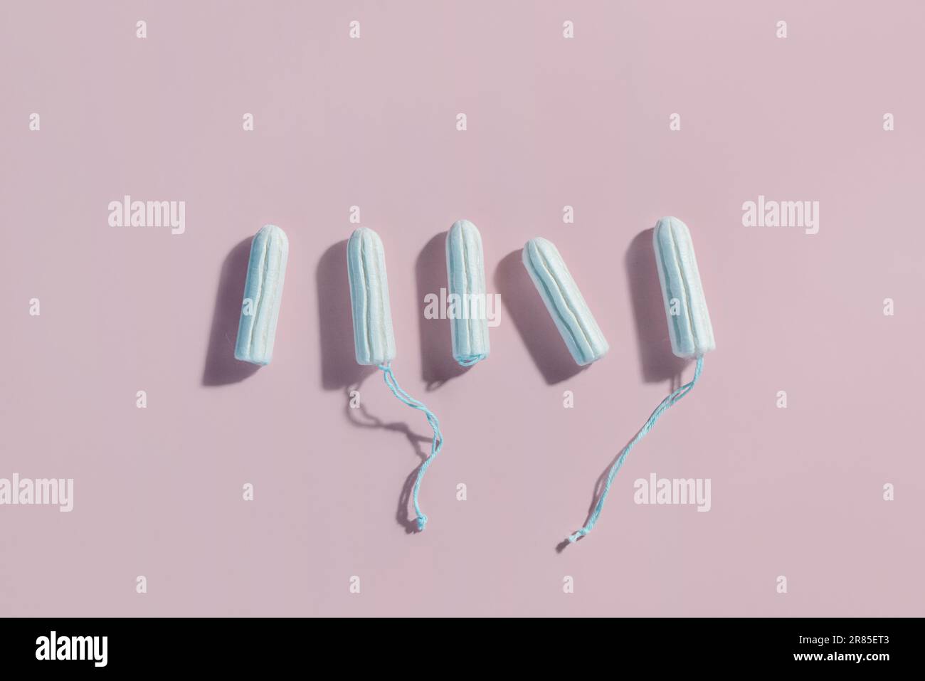 Menstrual tampons on lilac background Stock Photo - Alamy