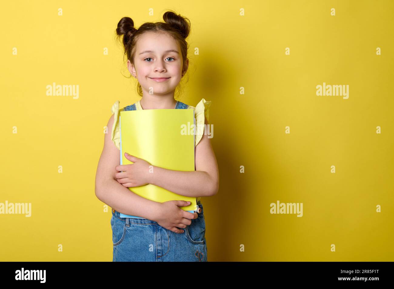Studio portrait of happy positive smiling kid girl, first grader ...