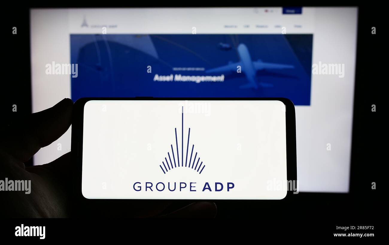 Person holding smartphone with logo of French airport operator company ...