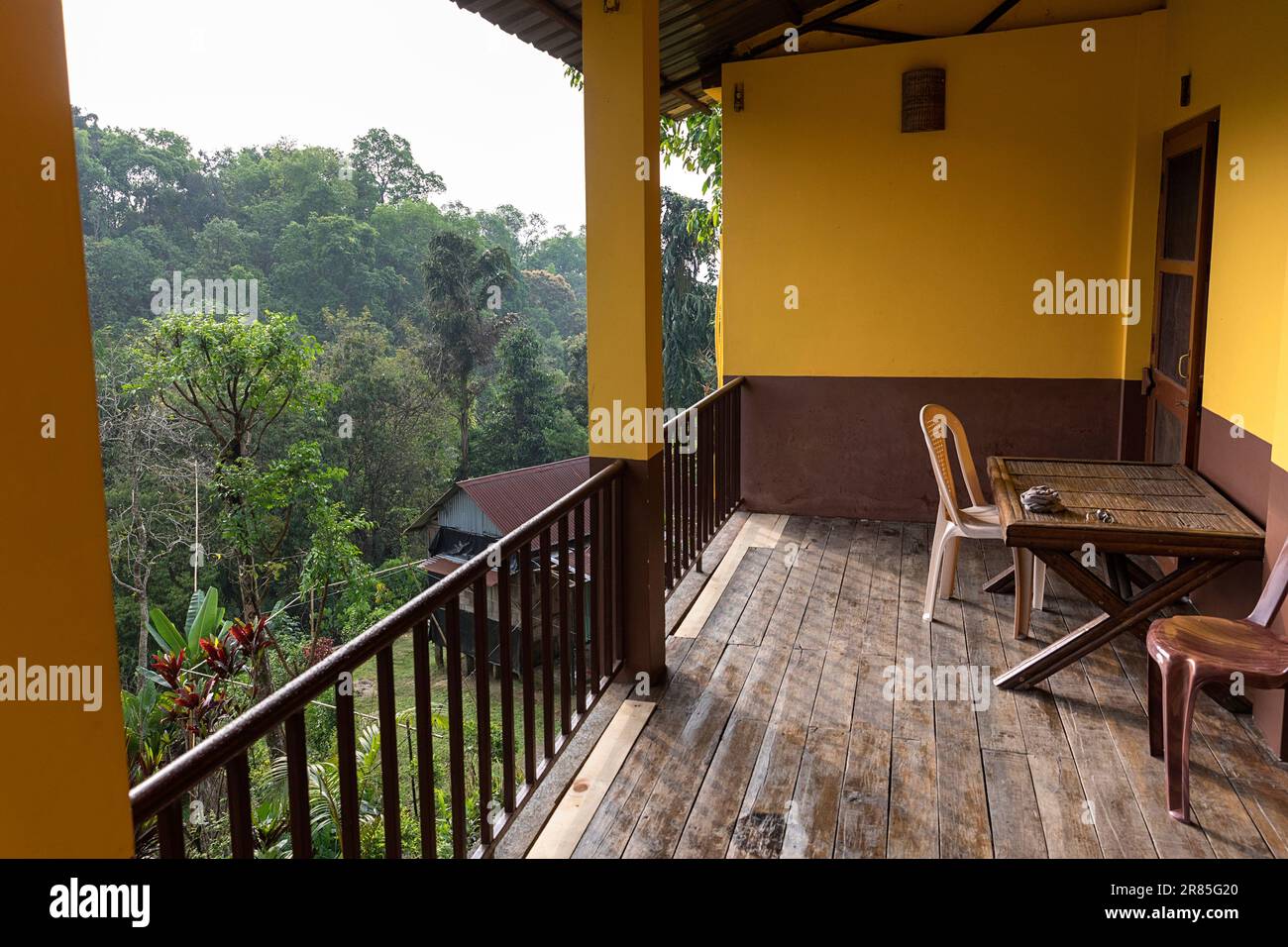 Sitting area on wooden terrace with a view overlooking rainforest with ...