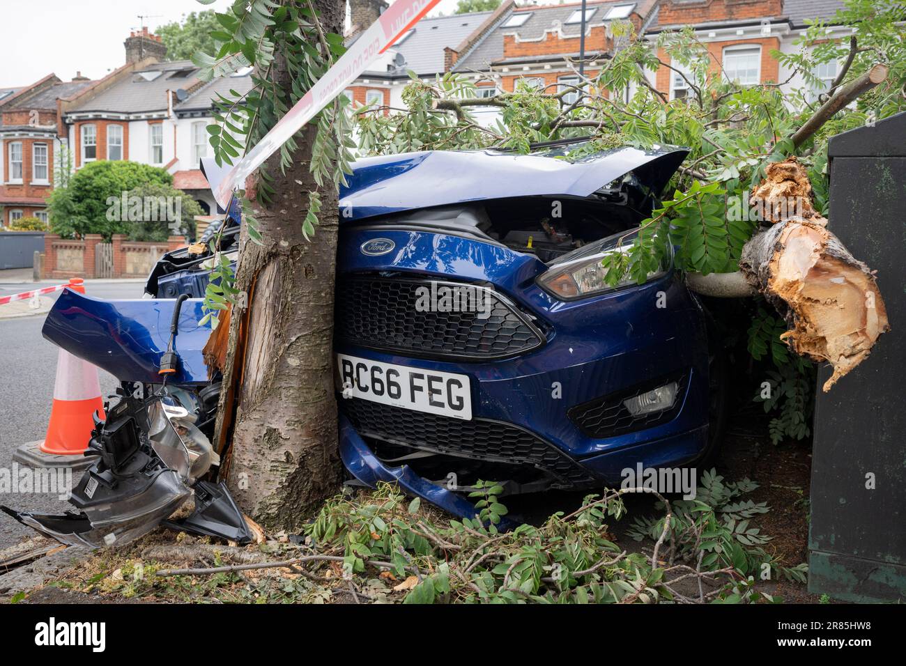 The aftermath of a crashed Ford hatchback that has come to rest against ...