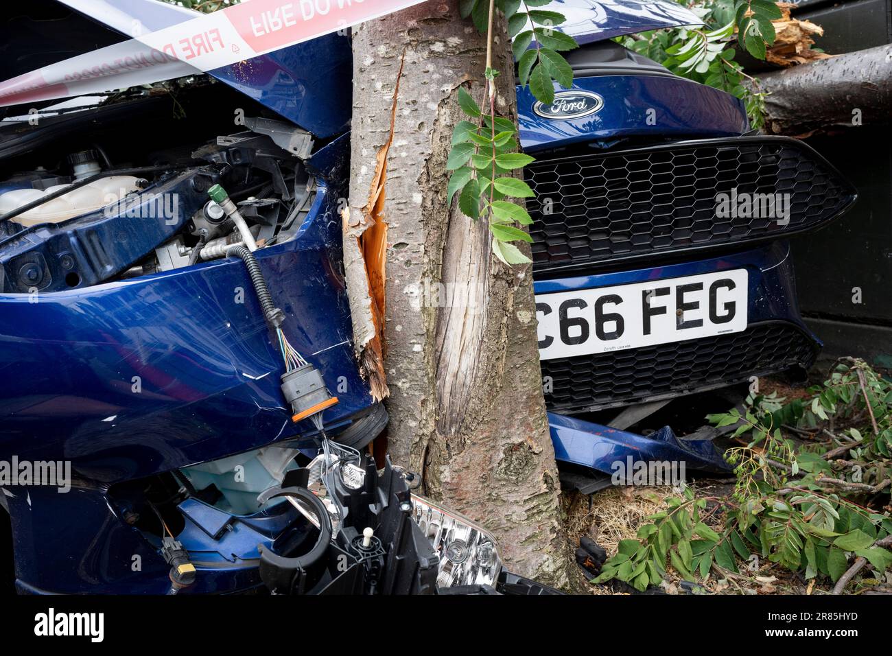 The aftermath of a crashed Ford hatchback that has come to rest against ...