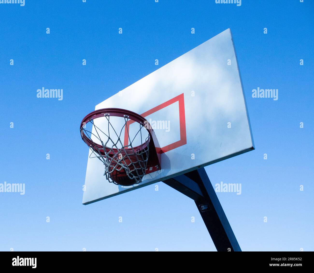 Basketball Hoop taken against a clear blue sky Stock Photo - Alamy
