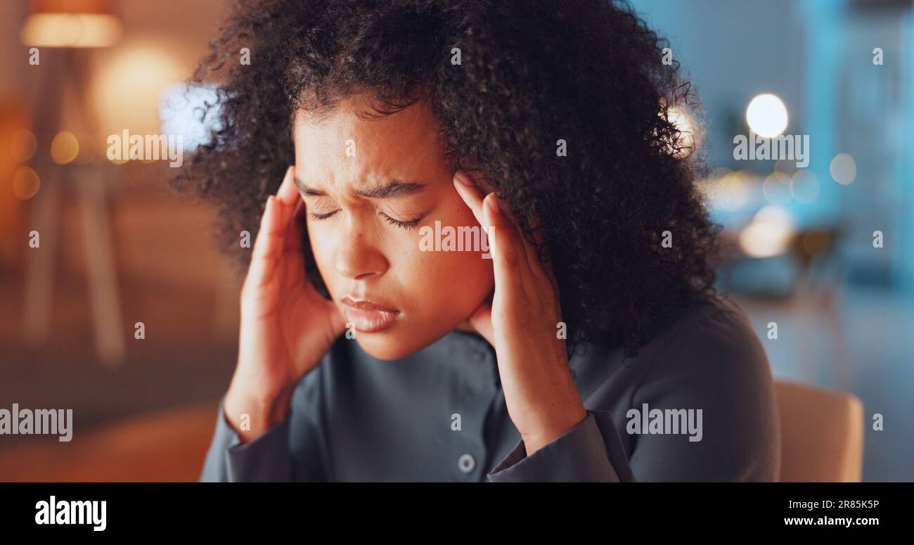 Stress, headache and woman in the office at night working on a ...
