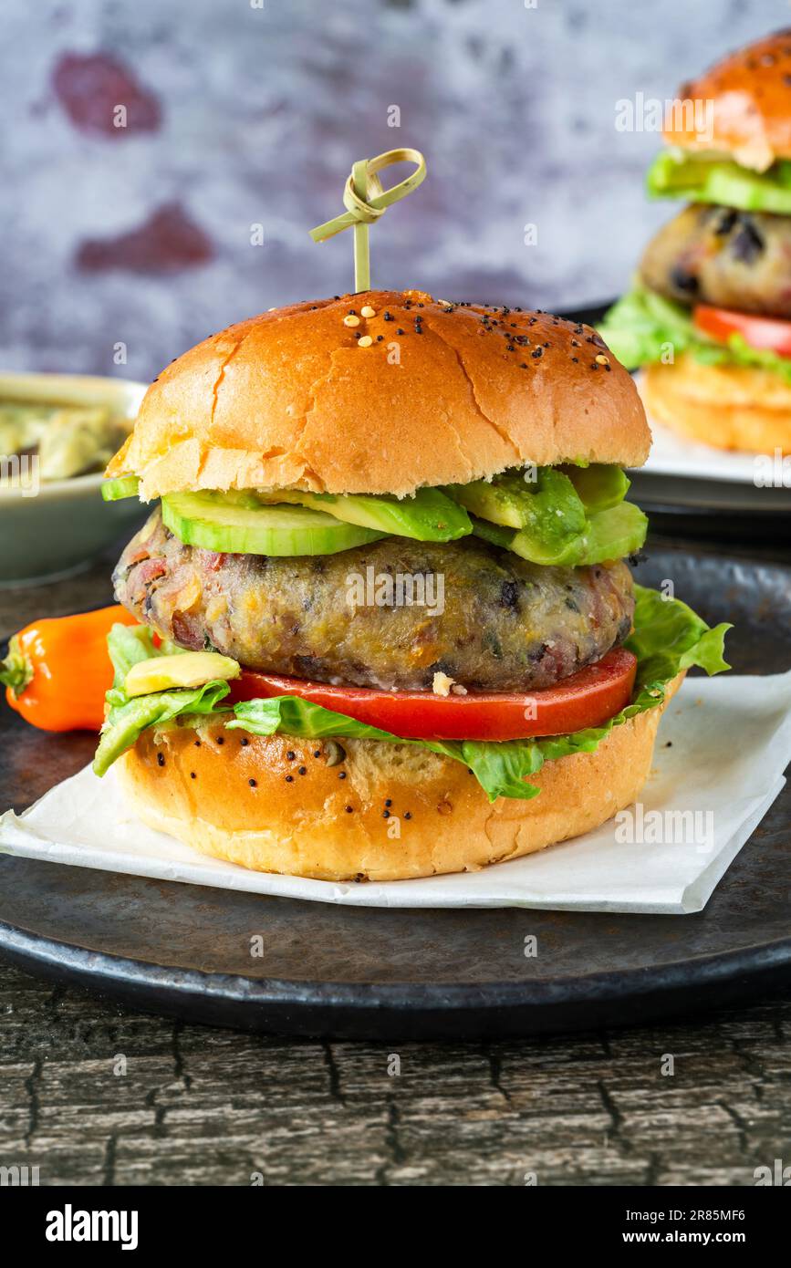 Plantain and black bean burger in brioche bun Stock Photo - Alamy