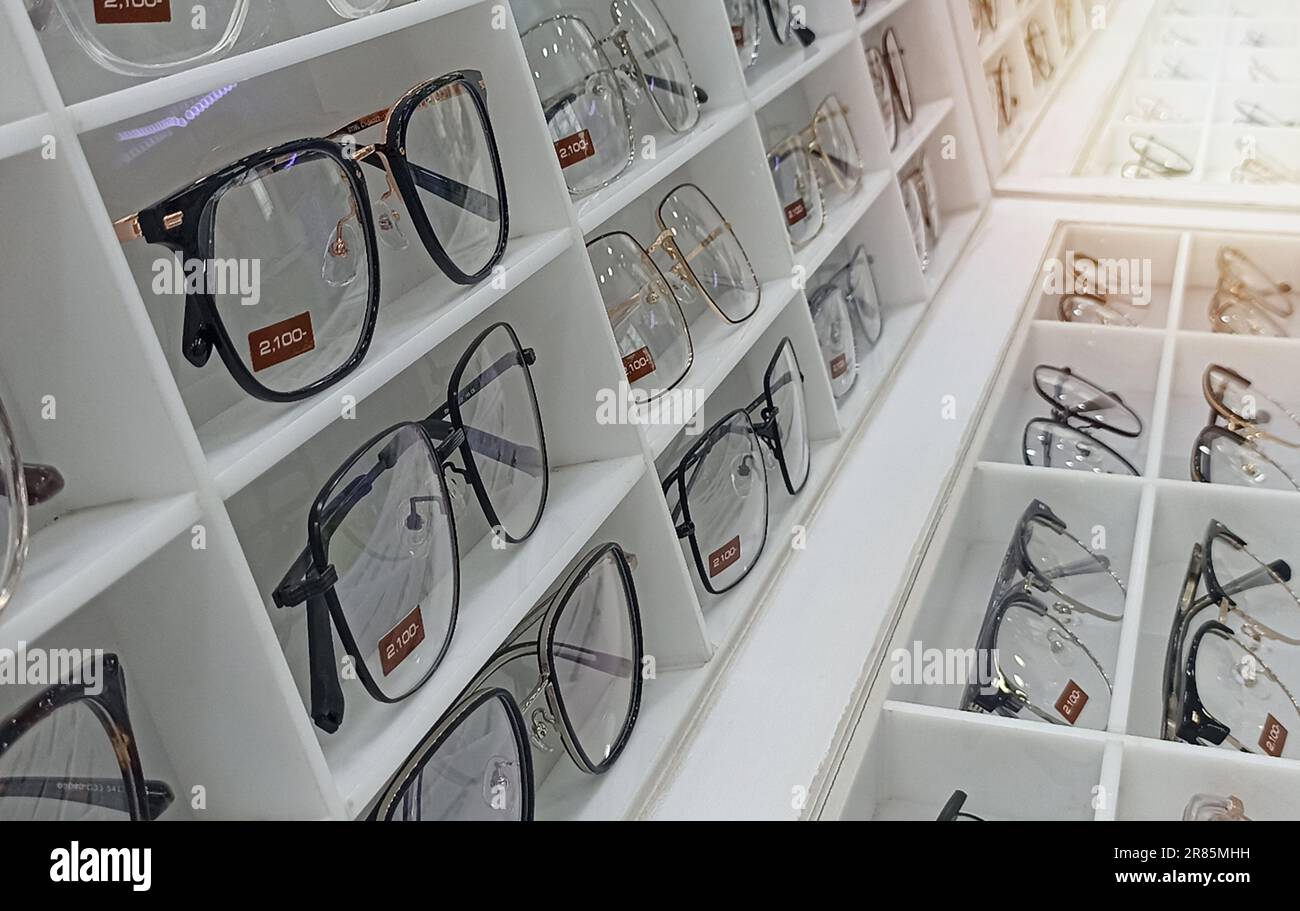Several pictures of eyeglasses are placed on the shelf Stock Photo - Alamy