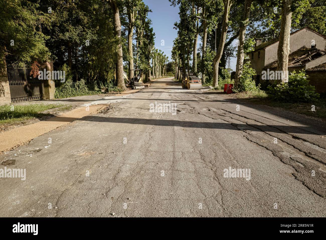 A photo capturing a broken road in Italy undergoing repair and ...
