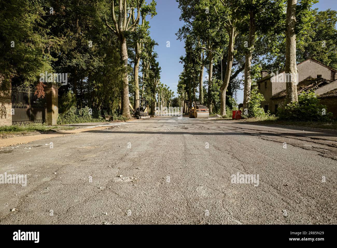 A photo capturing a broken road in Italy undergoing repair and ...