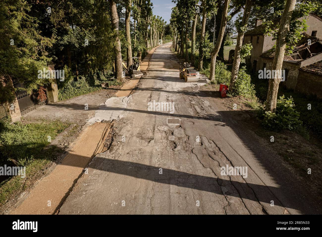 A photo capturing a broken road in Italy undergoing repair and ...