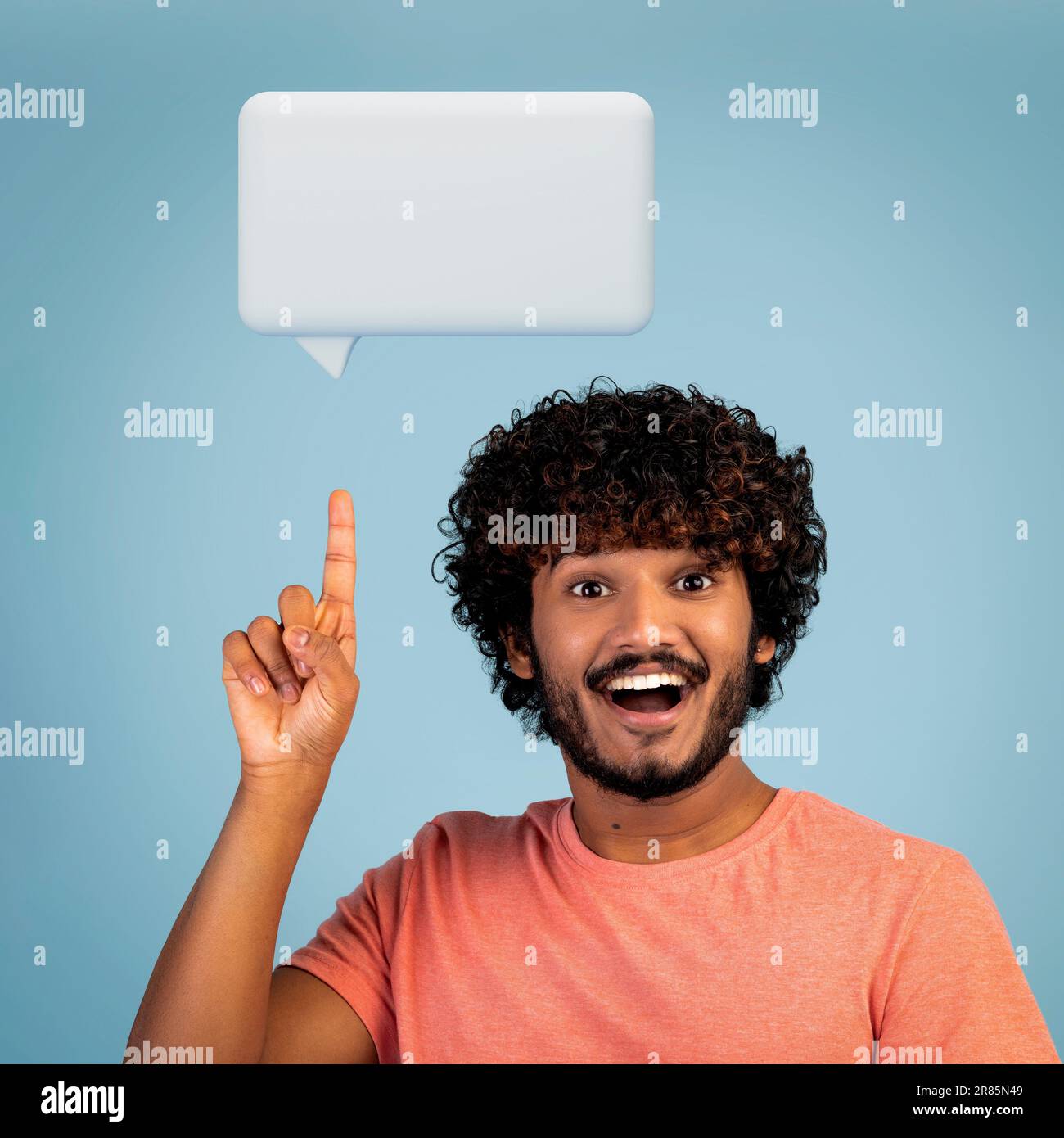 Indian guy pointing finger showing text bubble icon, blue background ...