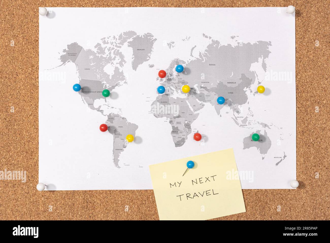 My next travel destination concept. Pushpins on world map on Corkboard ...
