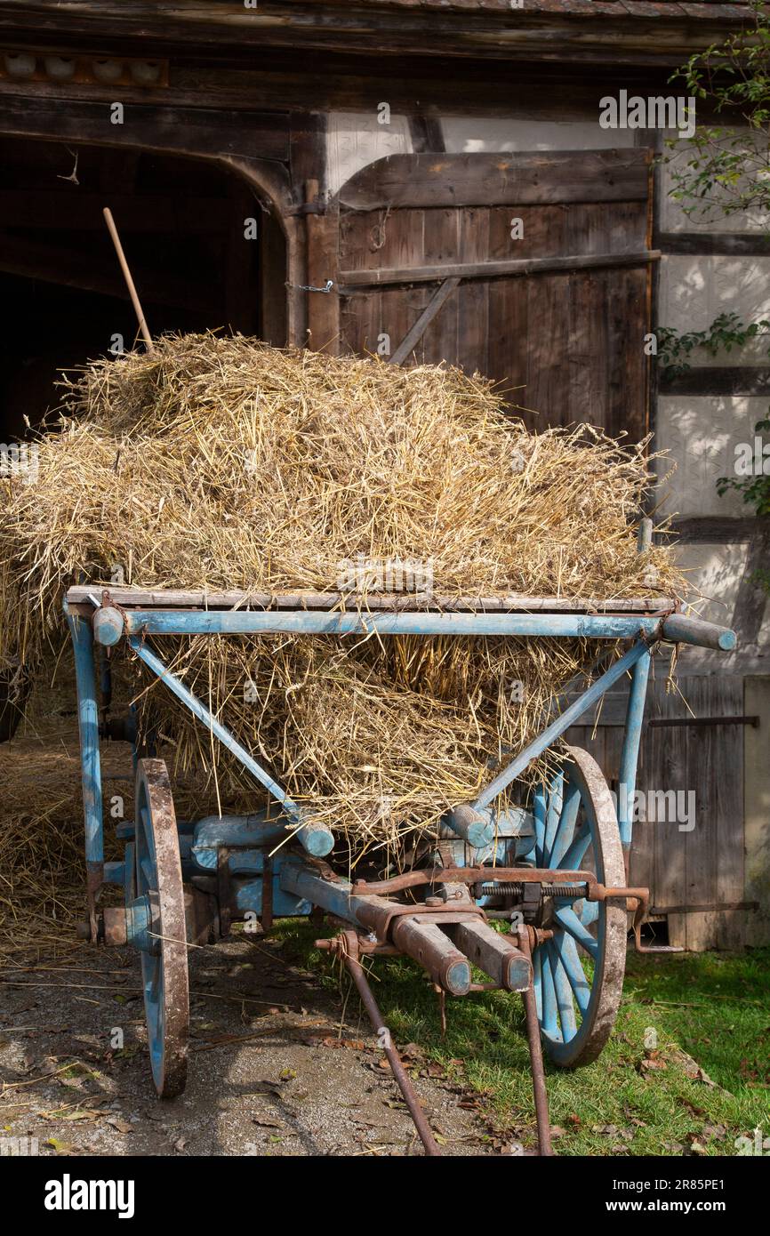 Old wooden hay wagon in front of a barn Stock Photo - Alamy