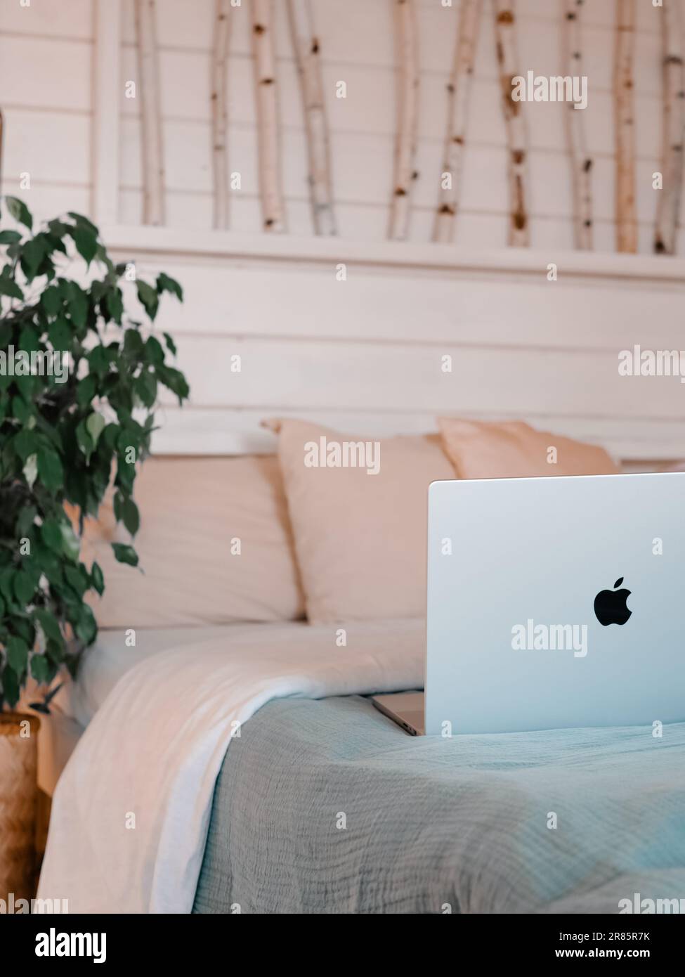 Macbook on bed in country house bedroom interior background. Silver ...