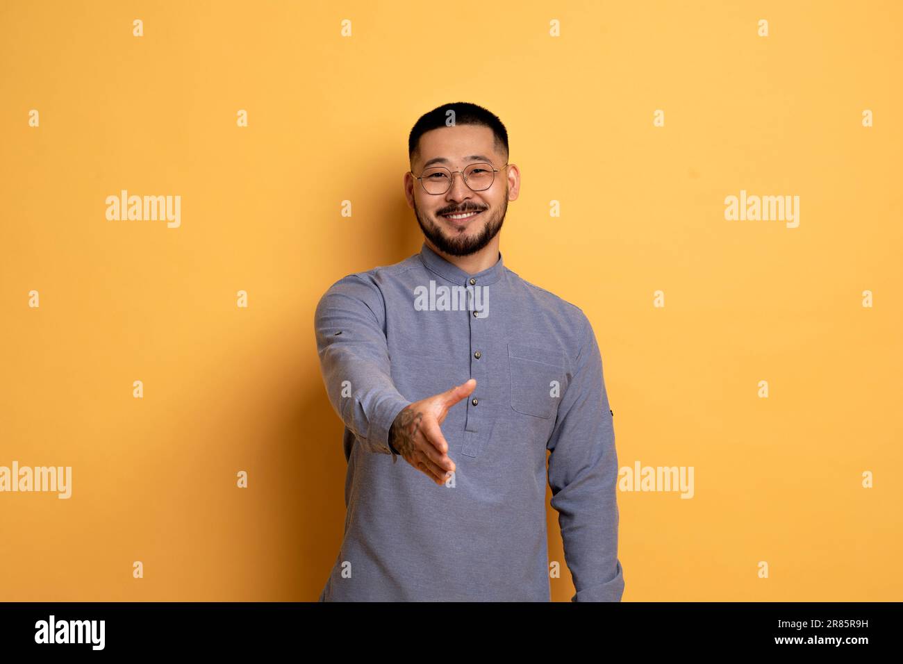 Smiling Young Asian Man Extending Hand For Handshake At Camera Stock ...