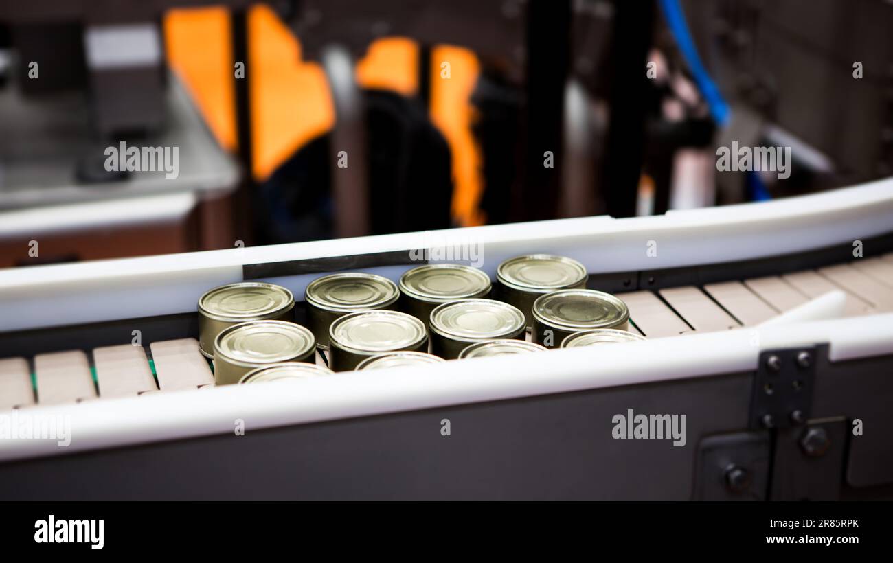 Food canned factory. Food tin cans on belt conveyor. Food industry ...