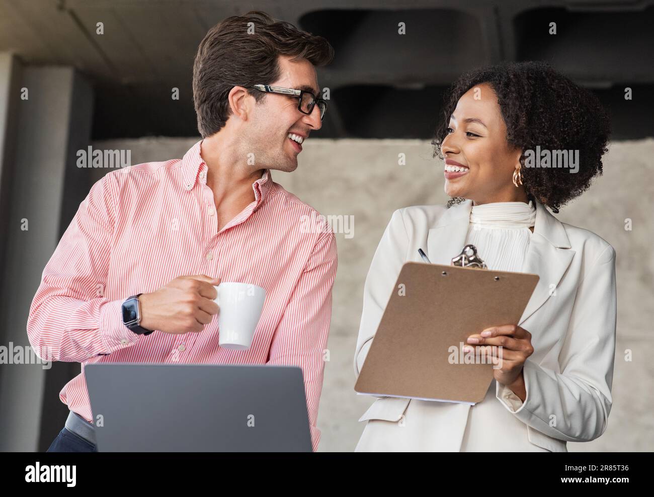 Happy young multiracial coworkers chatting and laughing, office ...