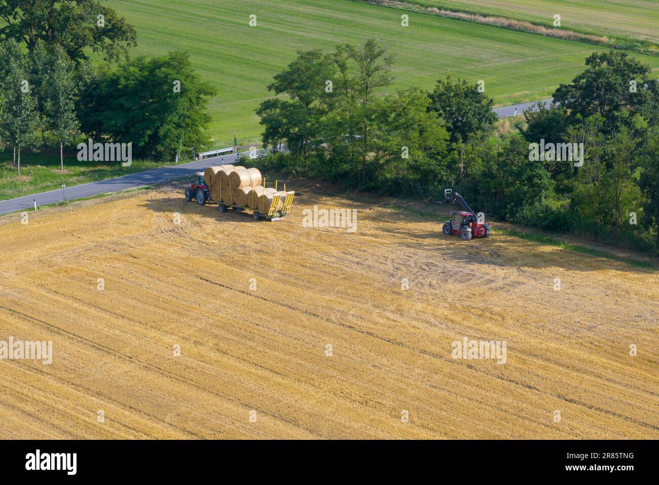 Aerial view of tractor collecting straw bales,Agricultural machine ...