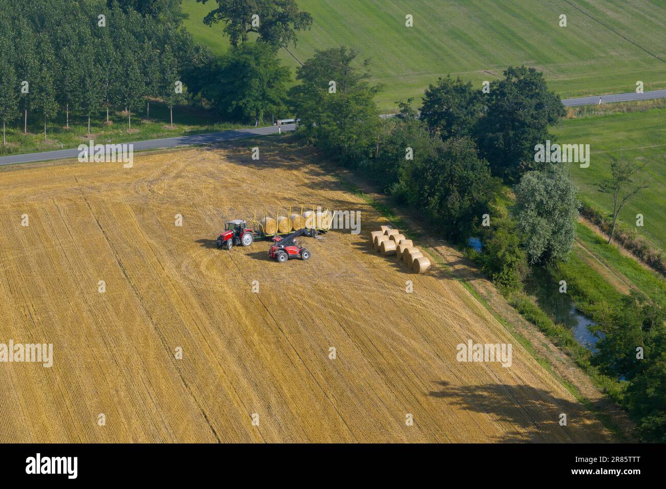 Aerial view of tractor collecting straw bales,Agricultural machine ...