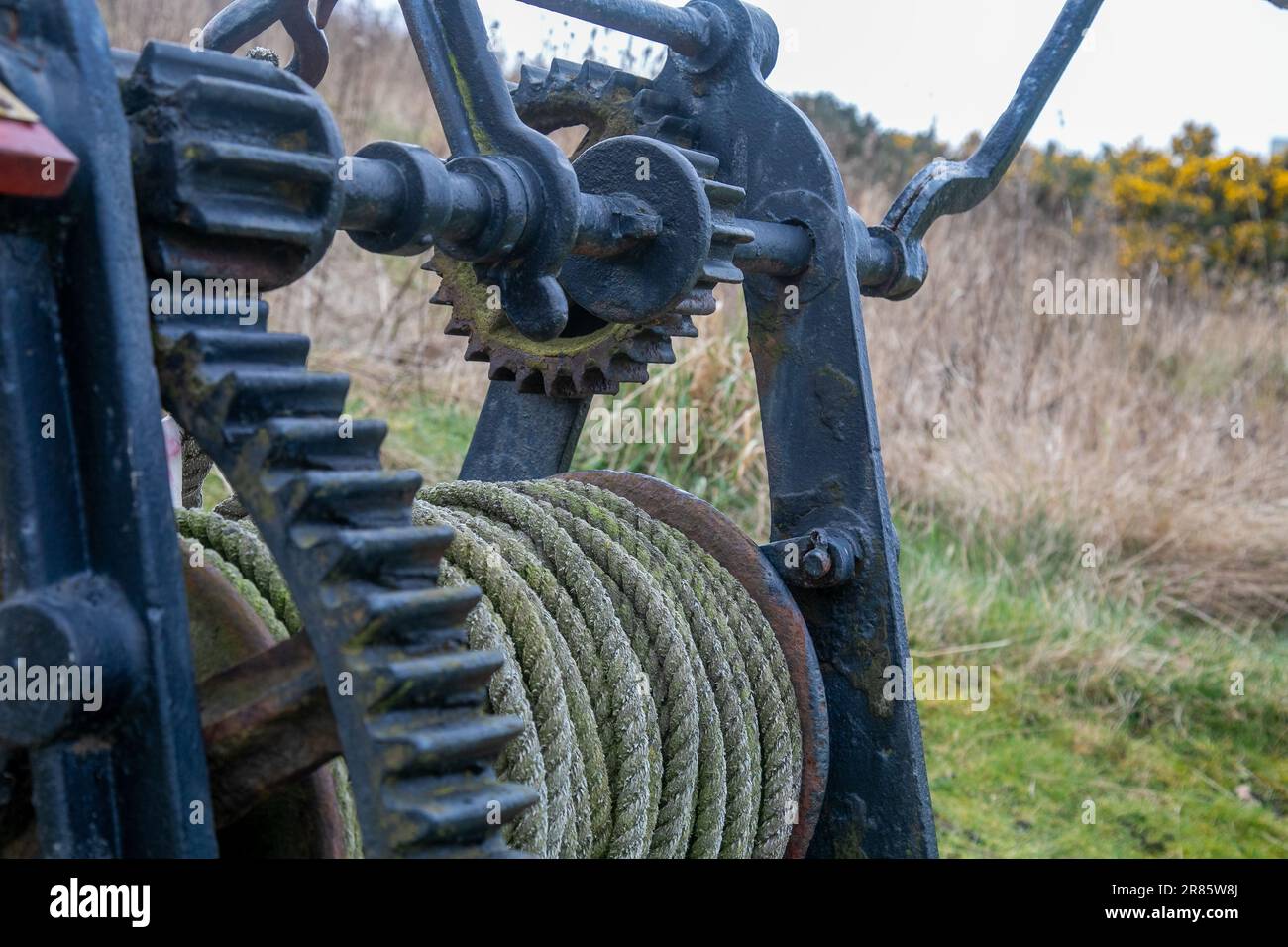 An old rope winch machine with large cogwheels Stock Photo - Alamy