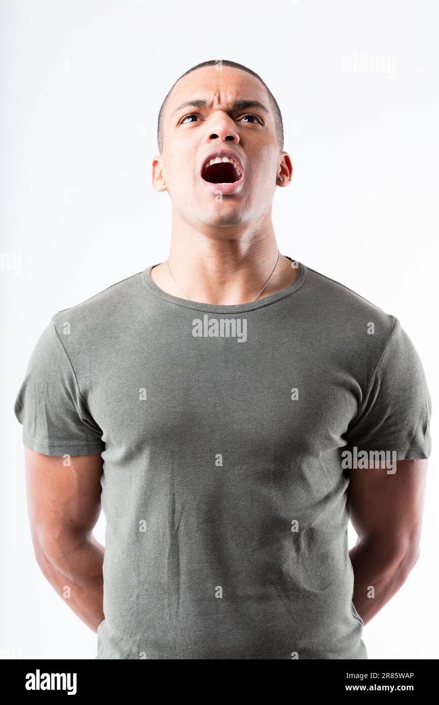 A man in military-style pose, shouting assertively. His high chin ...