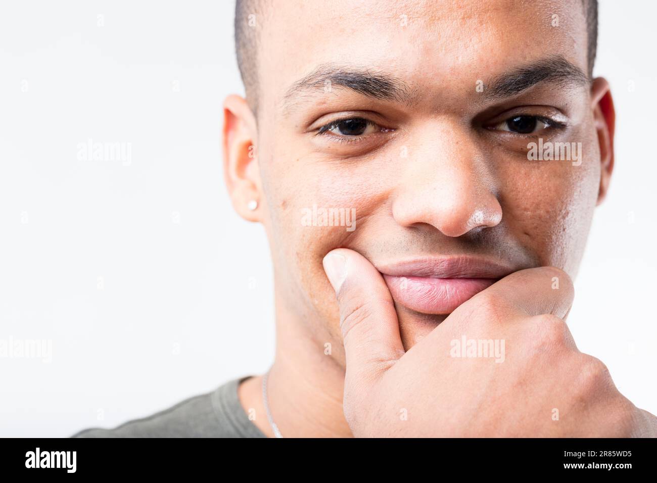 Extreme close-up portrait of black man, who's deep in thought. He's ...