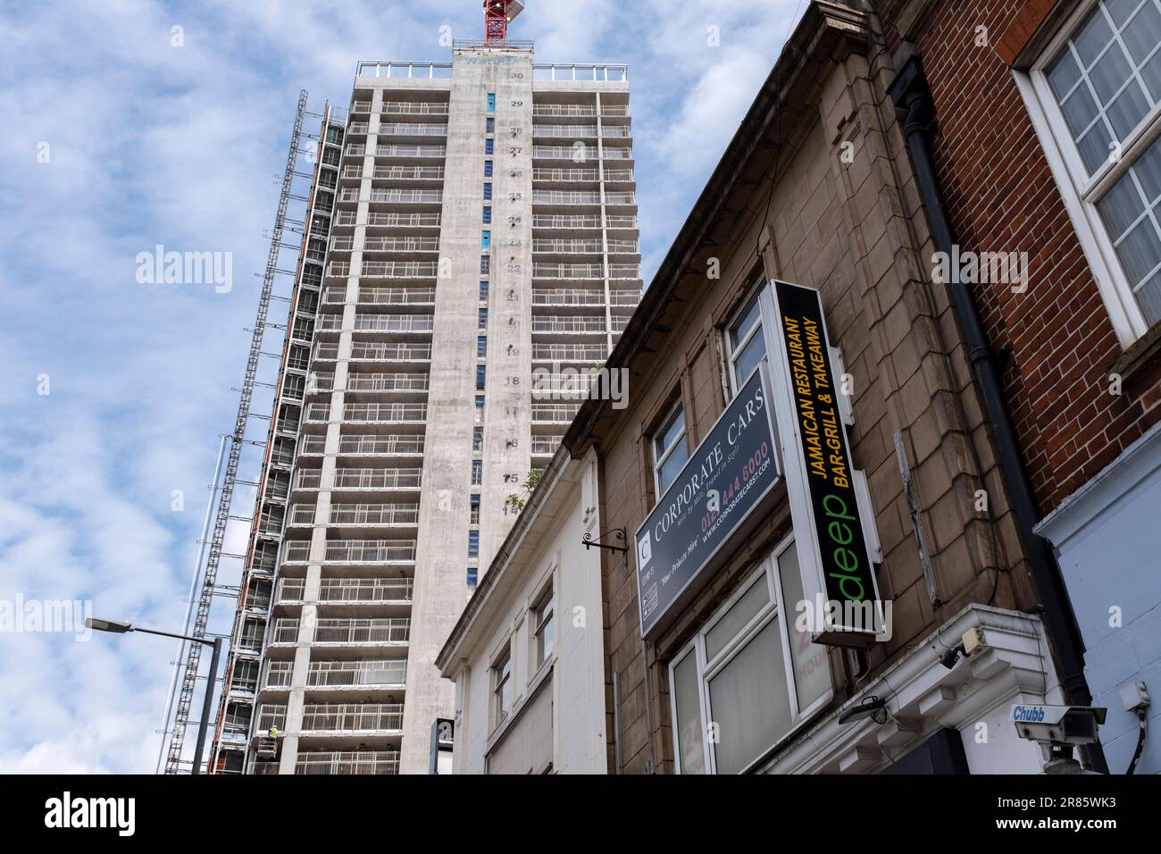 New residential apartment buildings under construction next to old low ...