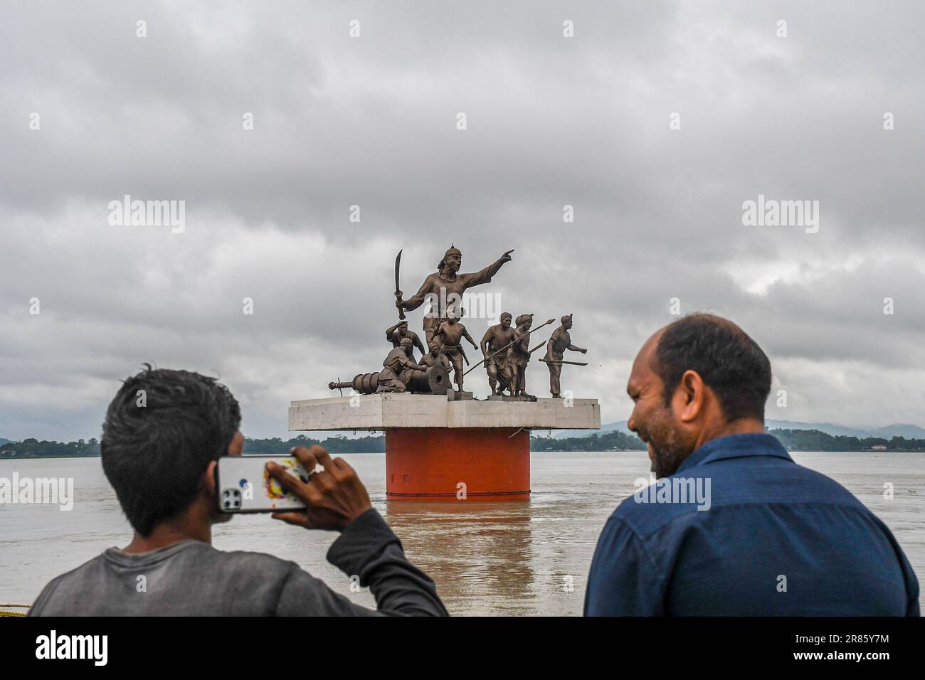 Guwahati, India. 17th June, 2023. A man talks on phone as dark clouds ...