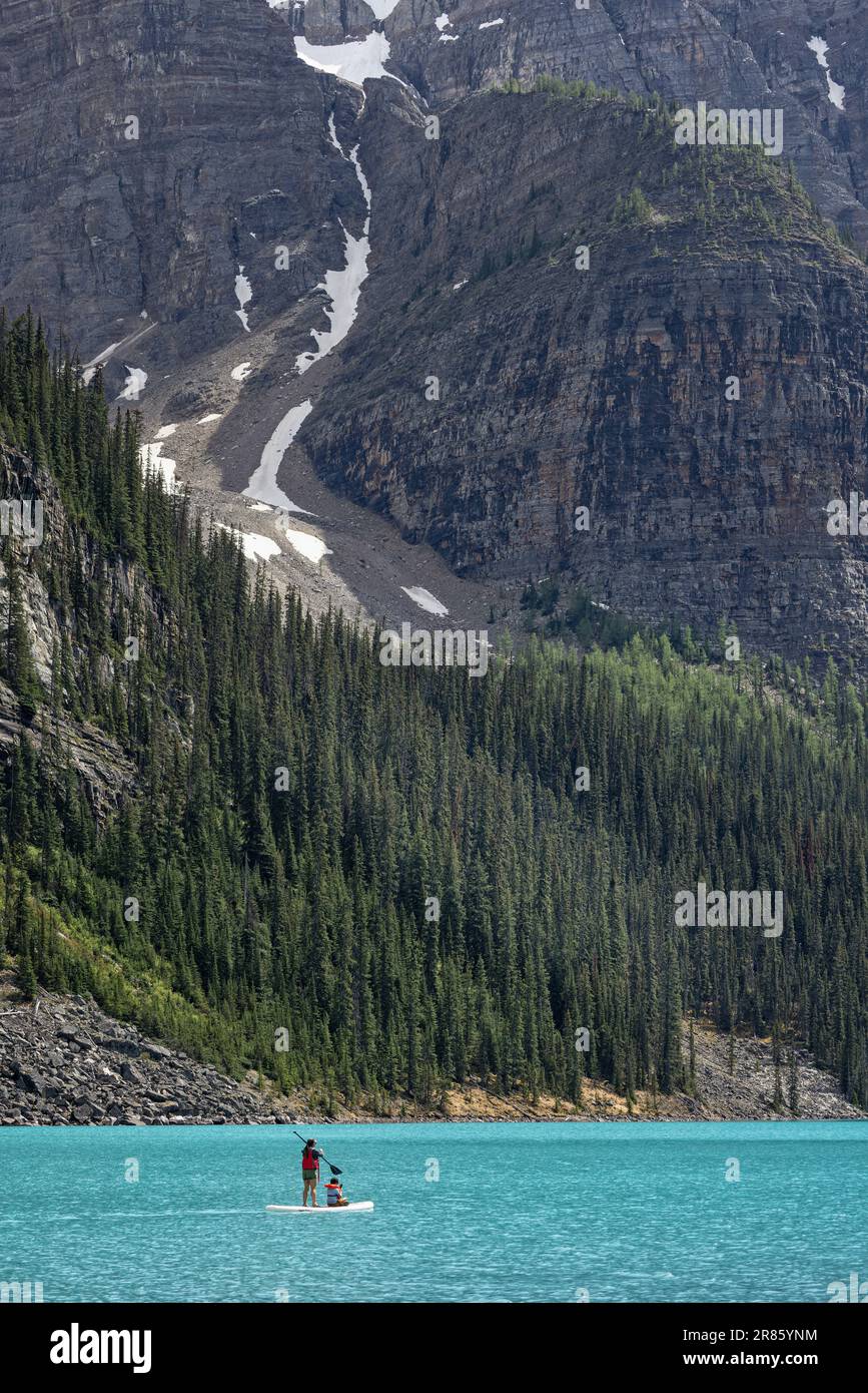 Mother and child paddle boarding on Moraine Lake in Banff National Park ...