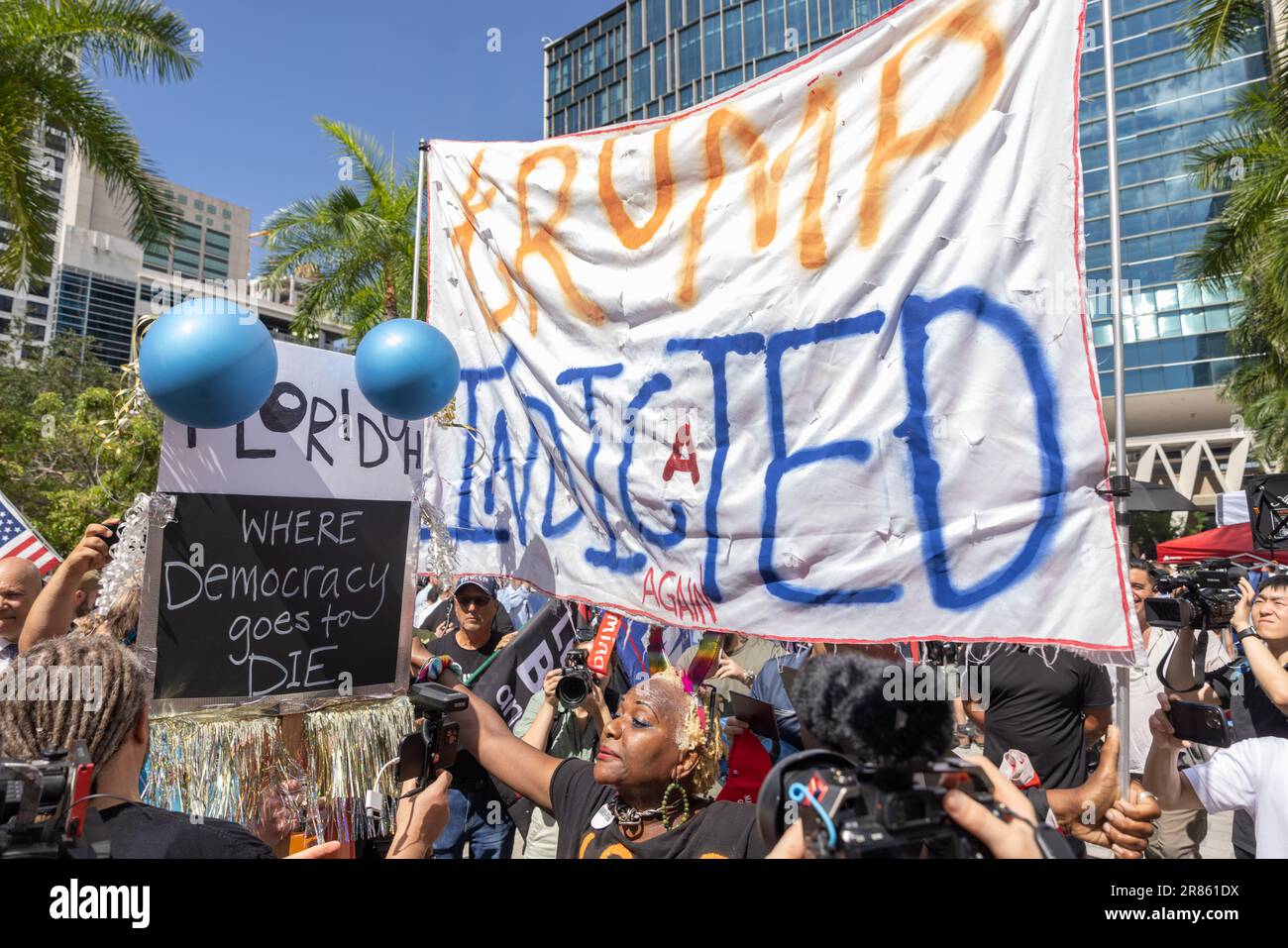 MIAMI, Fla. – June 13, 2023: Demonstrators and others are seen near a ...