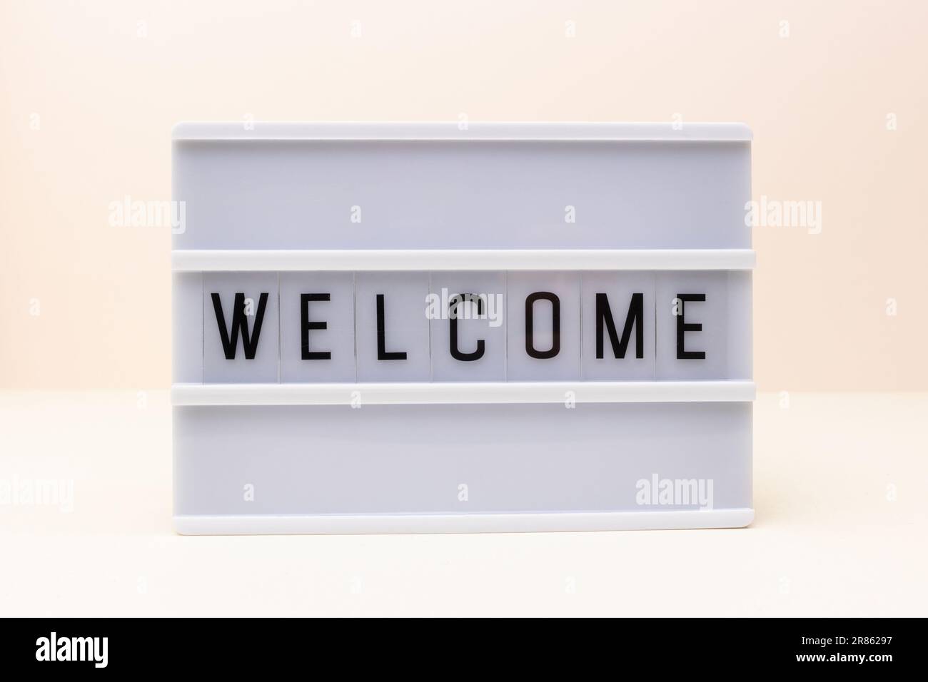 Word Welcome. Lightbox with letters in front of beige background Stock ...