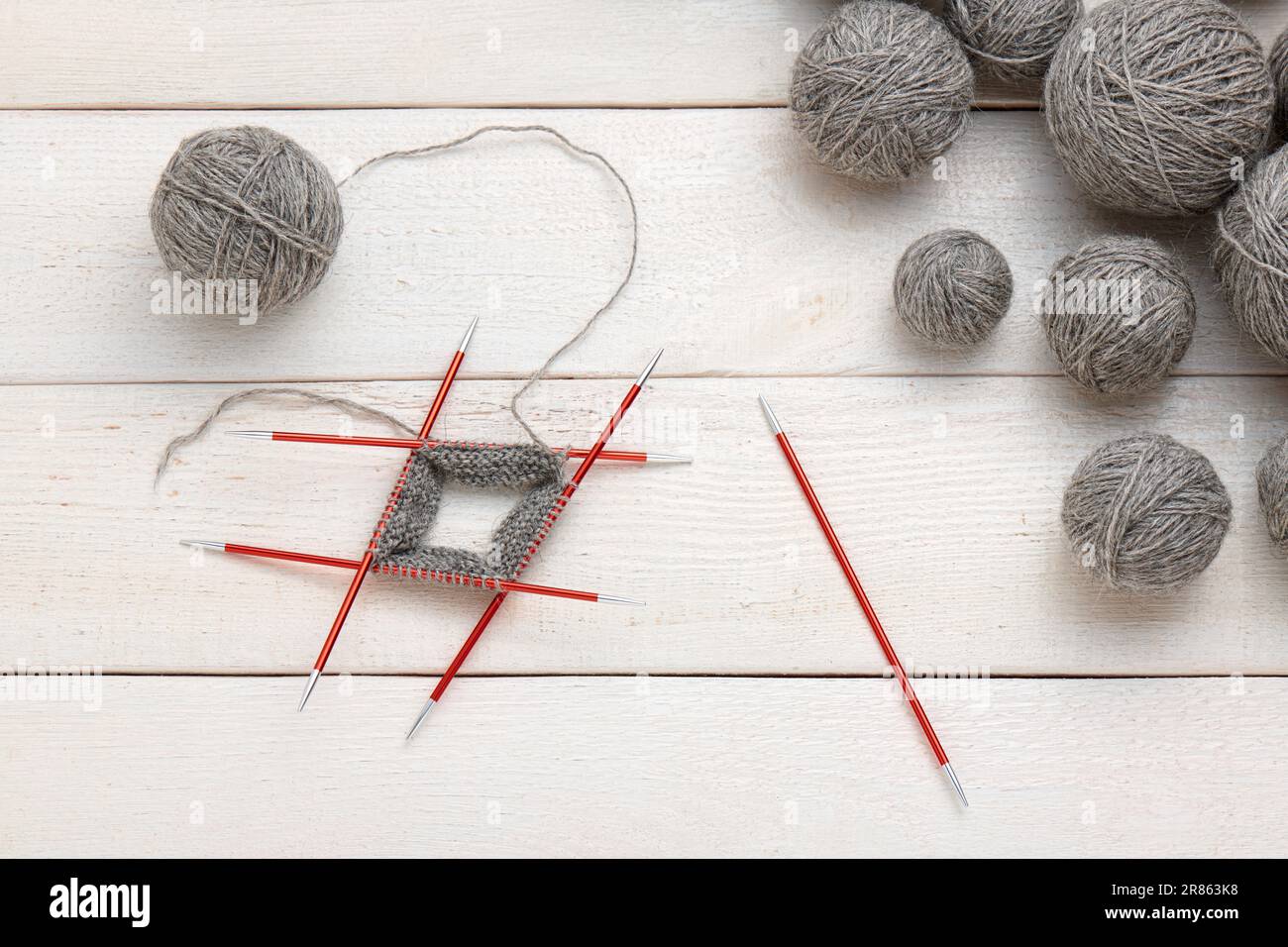 The process of knitting in the circle on double-sided knitting needles ...