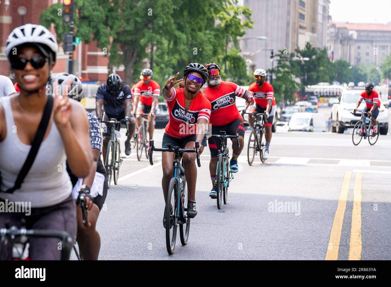 A group of bicyclists head out on a bike ride from a Juneteenth health ...