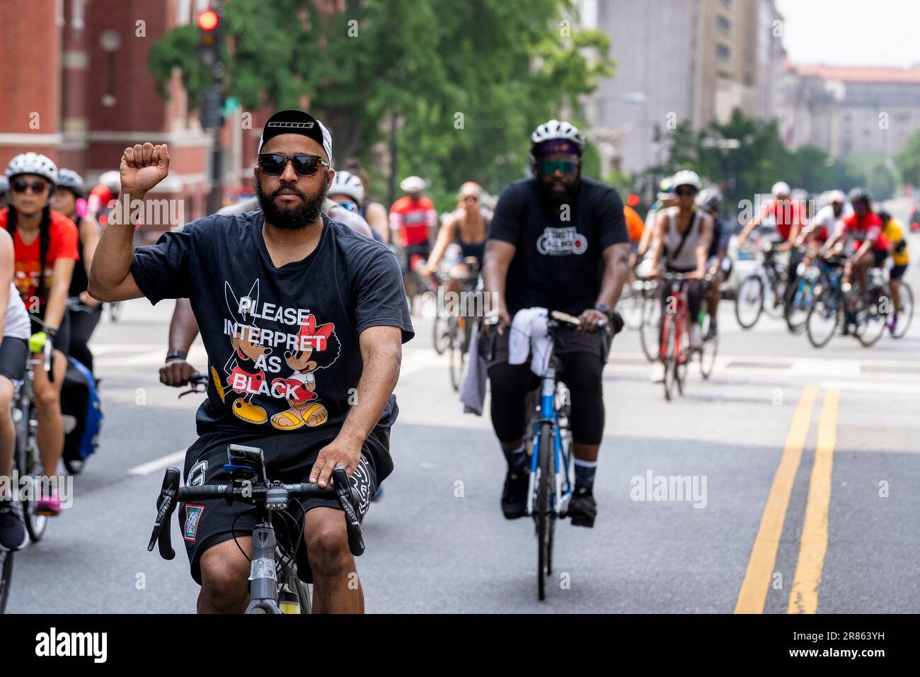 A group of bicyclists head out on a bike ride from a Juneteenth health ...