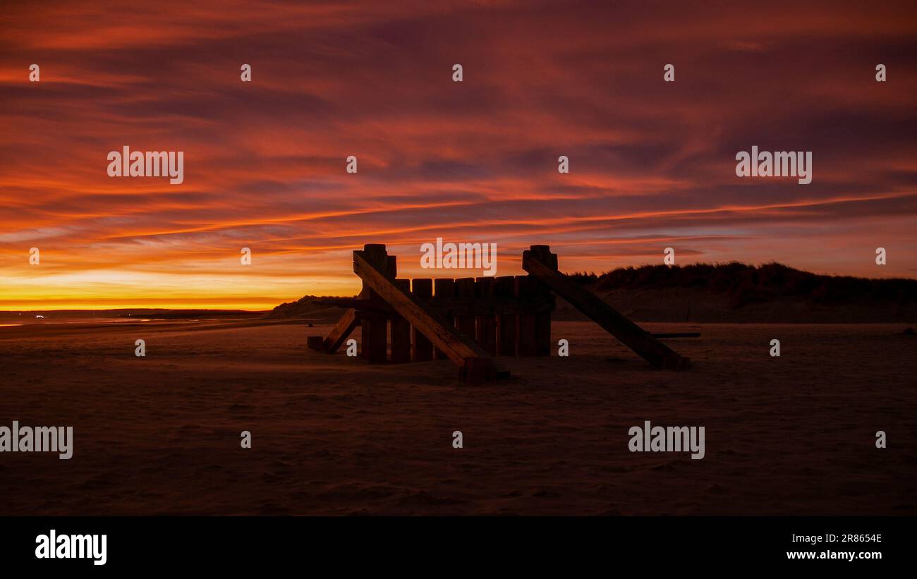 A wooden structure on the beach at scenic sunrise Stock Photo - Alamy