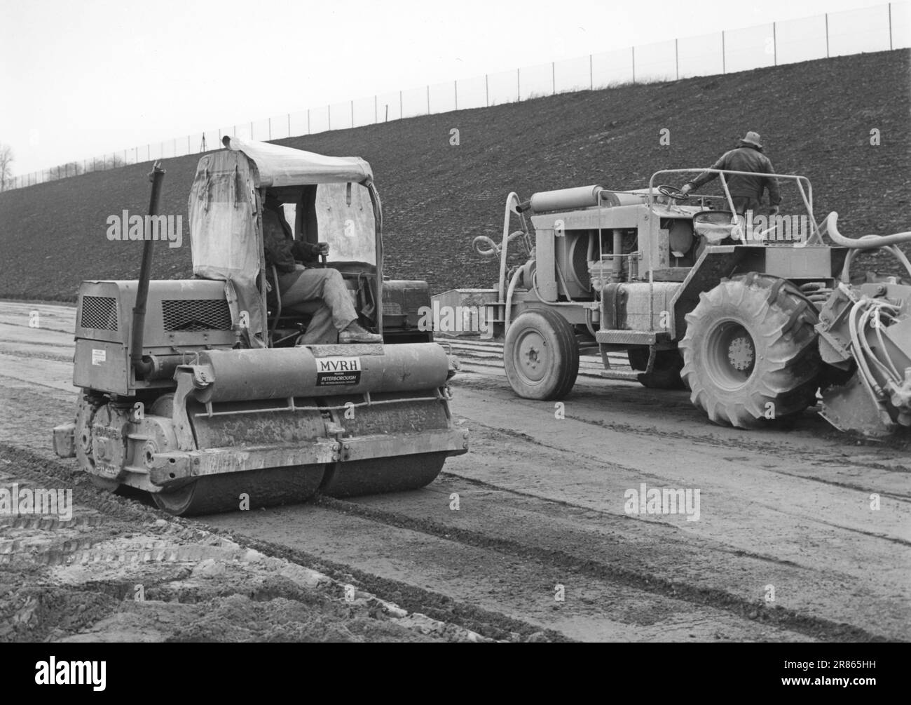 Construction of the M11 MotorwayRoad worker Stock Photo - Alamy