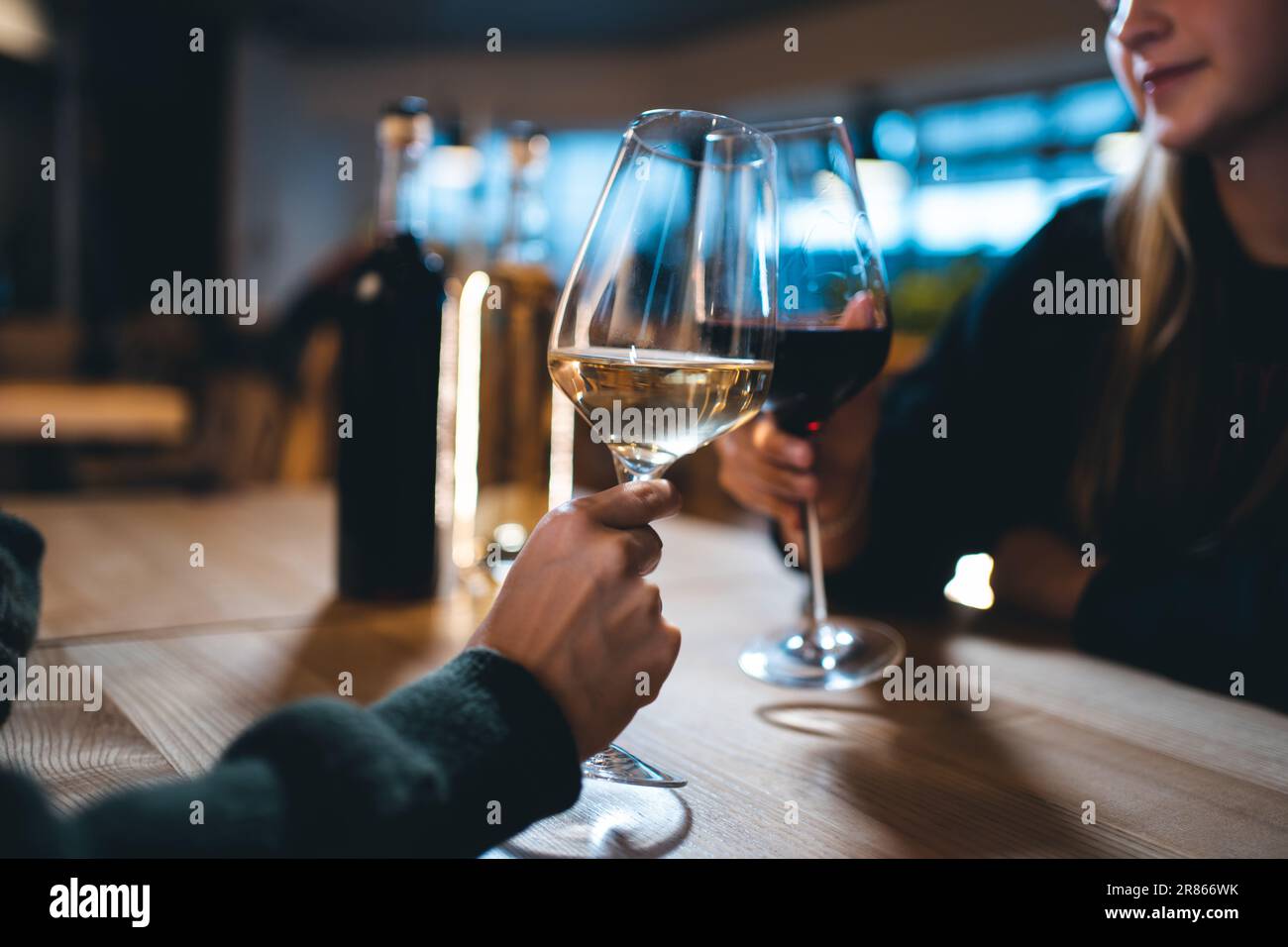 two person cheering and celebrate and drink red and white wine in ...
