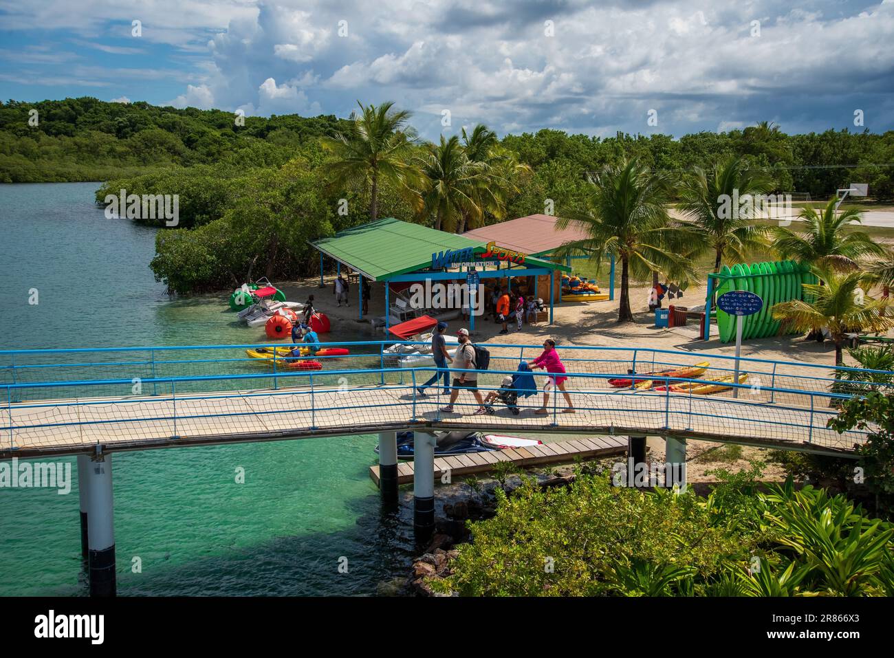 A group of people walking on a bridge in Roatan cruise port and ...