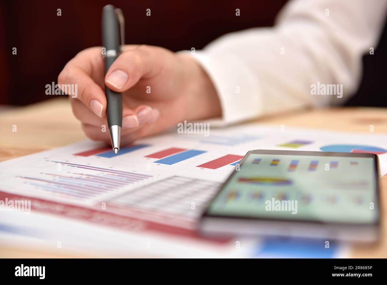 Mobile phone with financial data in form of charts and diagrams ...
