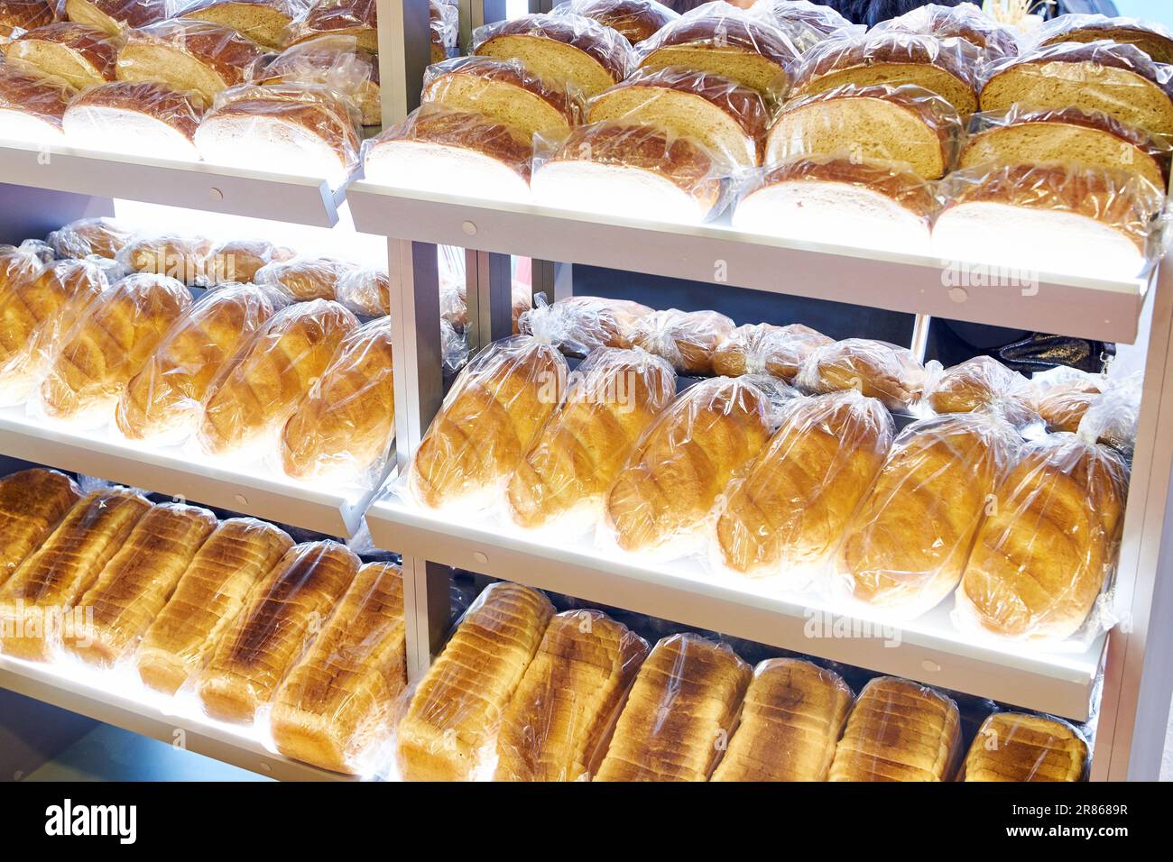 Fresh bread on shelves in a bakery Stock Photo - Alamy