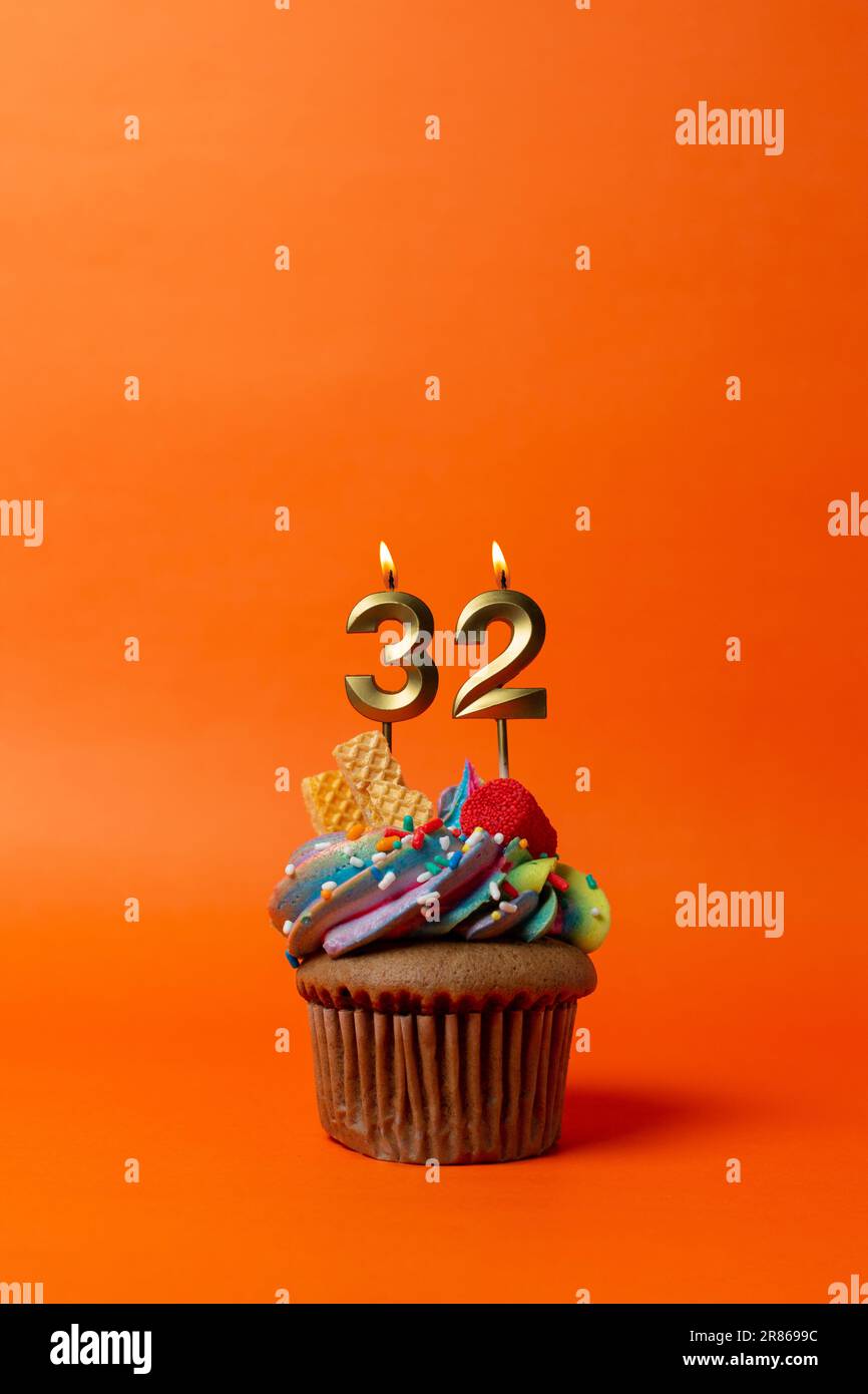 birthday cake with number 32 - cupcake on orange background with ...