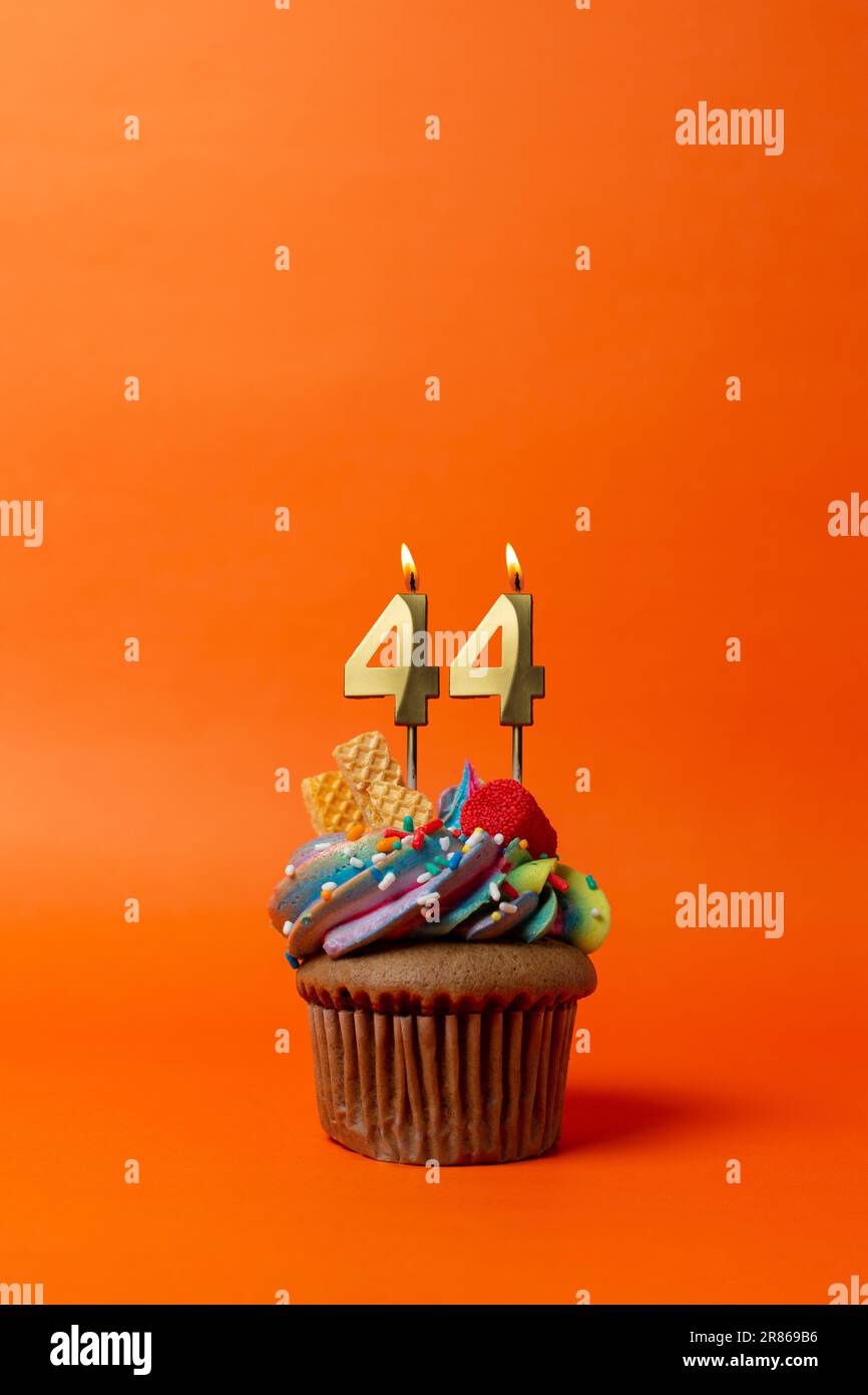 birthday cake with number 44 - cupcake on orange background with ...