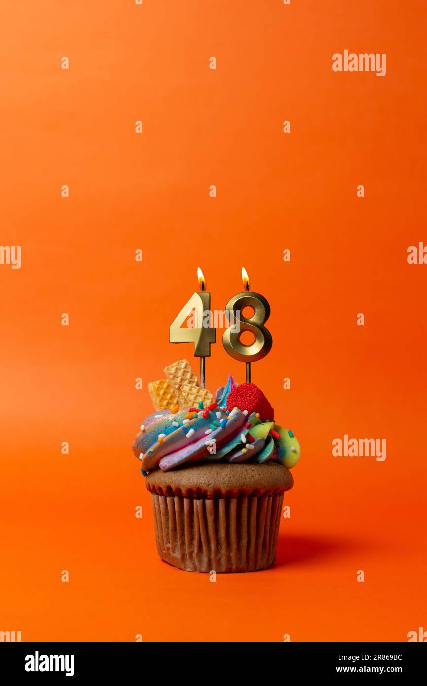 birthday cake with number 48 - cupcake on orange background with ...