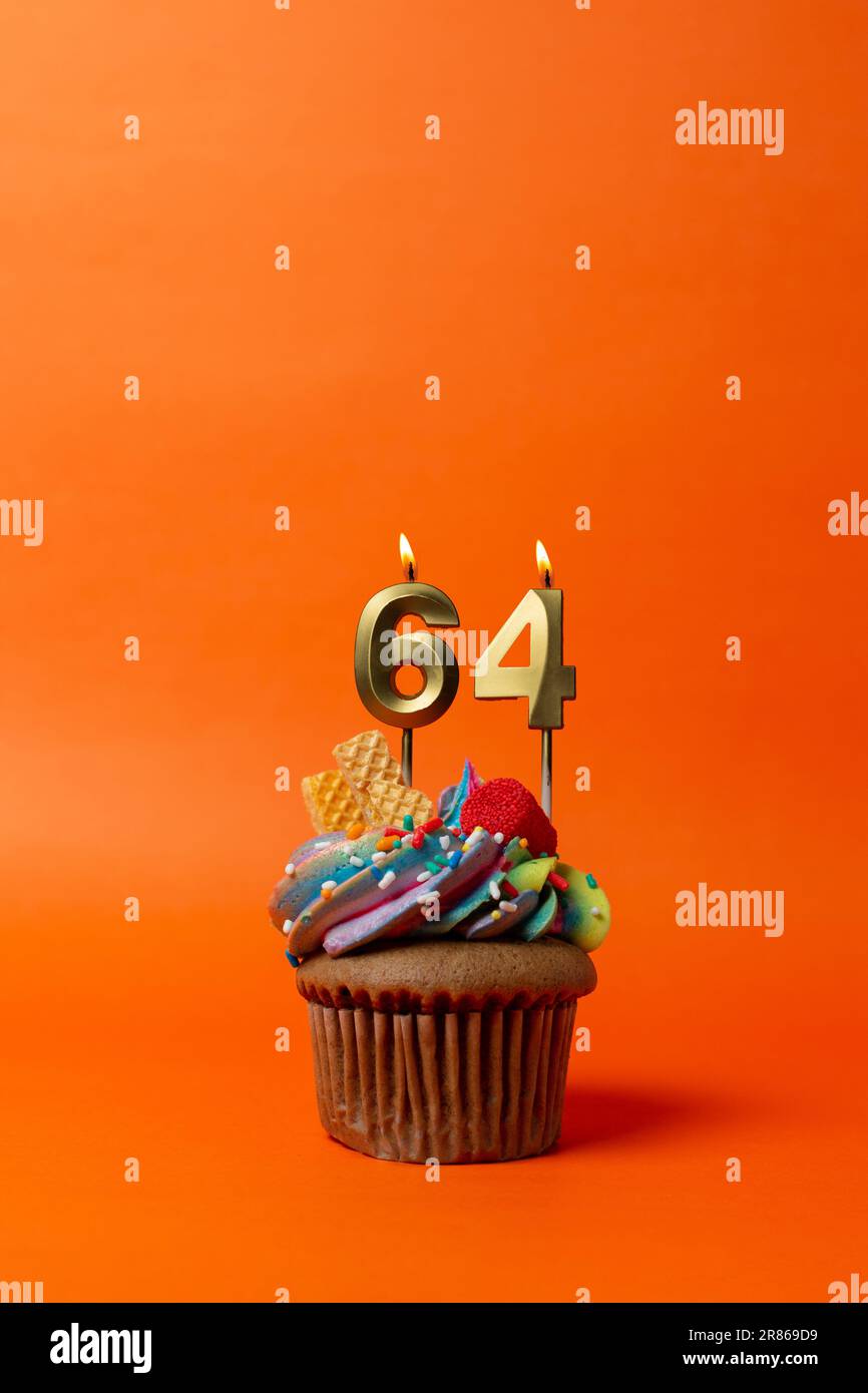 birthday cake with number 64 - cupcake on orange background with ...