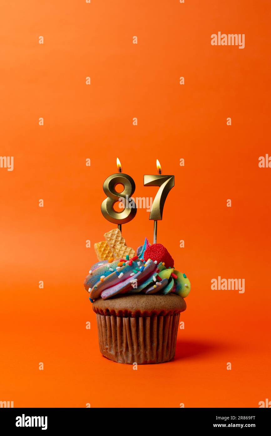 birthday cake with number 87 - cupcake on orange background with ...